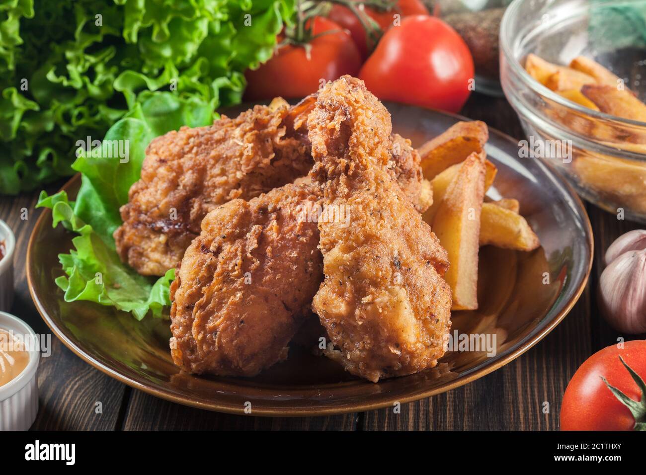 Crispy fried kentucky chicken legs with french fries in a plate Stock ...
