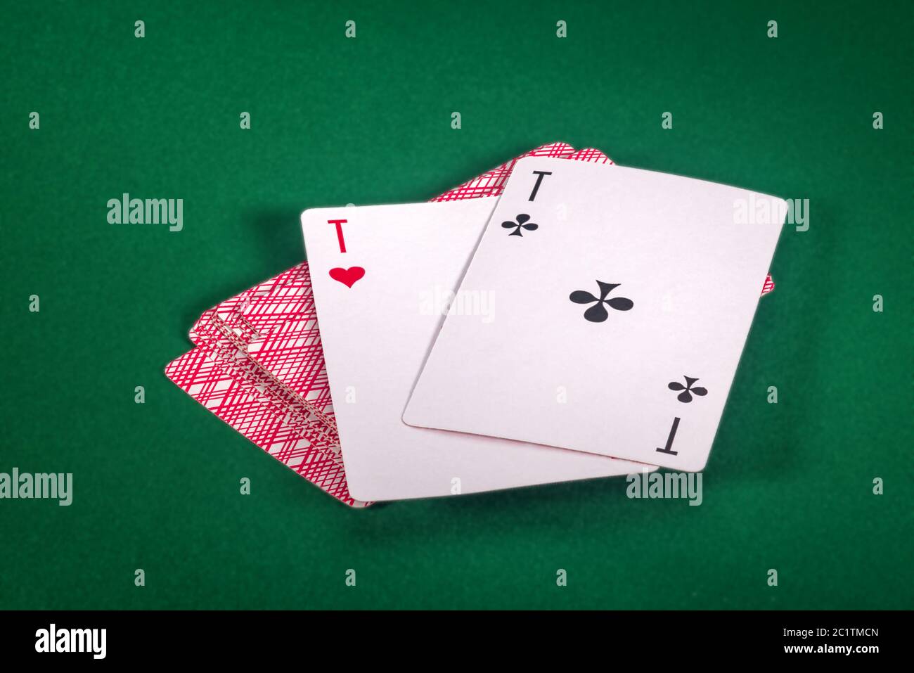 playing card ACE on an inverted deck of cards on a green table Stock ...