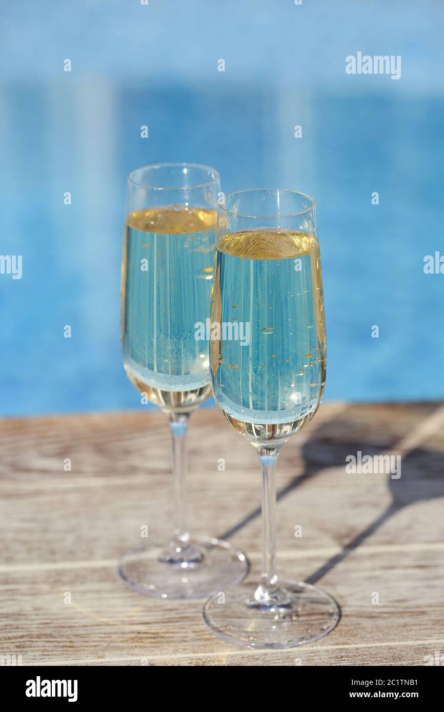 Champagne glasses near swimming pool Stock Photo - Alamy