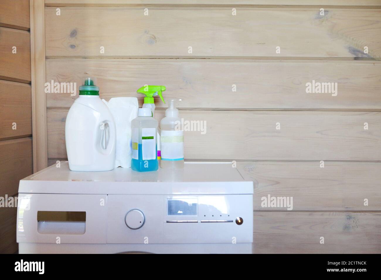 Plastic cleaning supplies on washing machine Stock Photo - Alamy