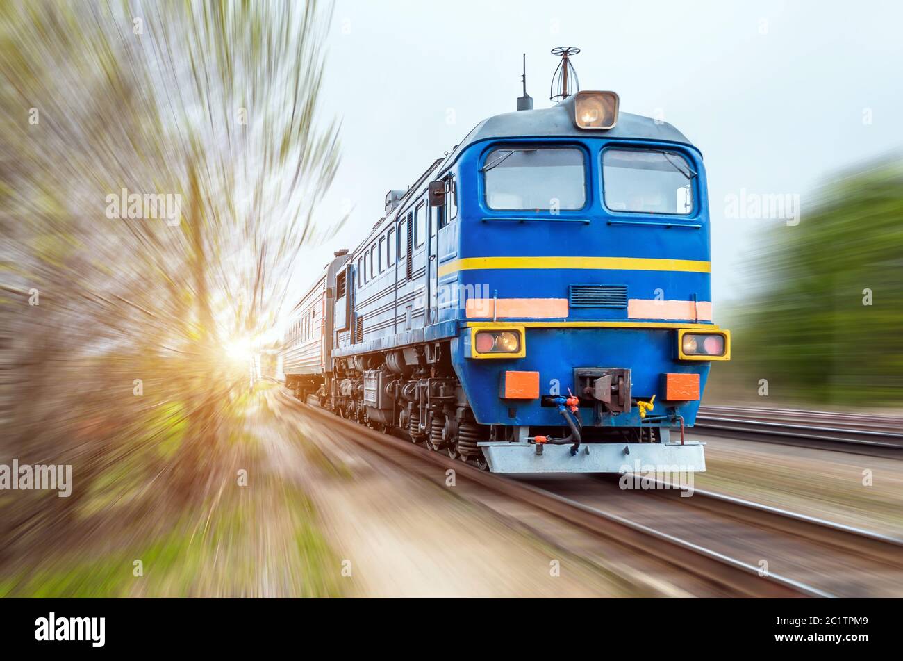 Locomotive in the composition of a passenger train in motion at speed ...