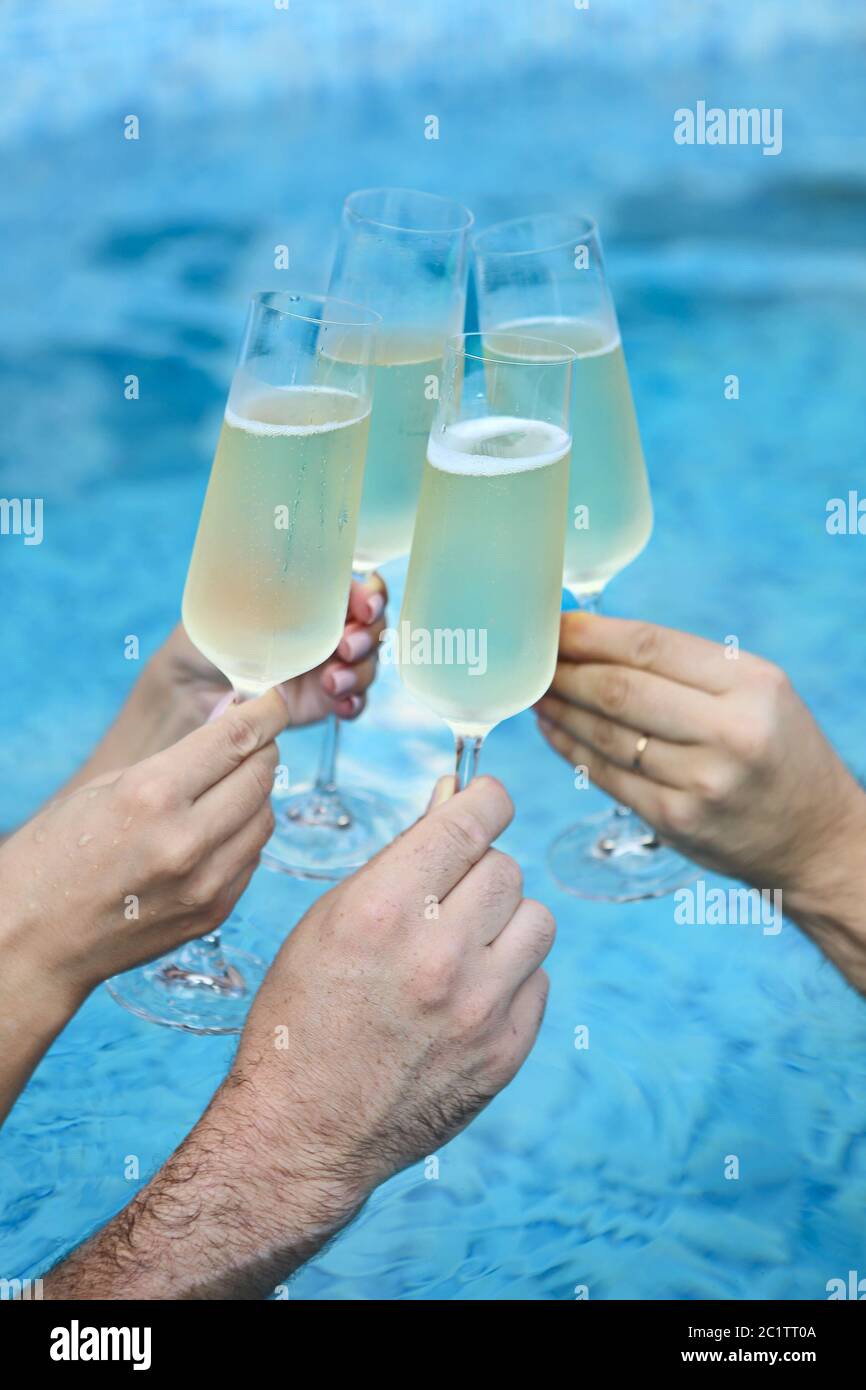 People hold champagne glasses in the pool Stock Photo - Alamy