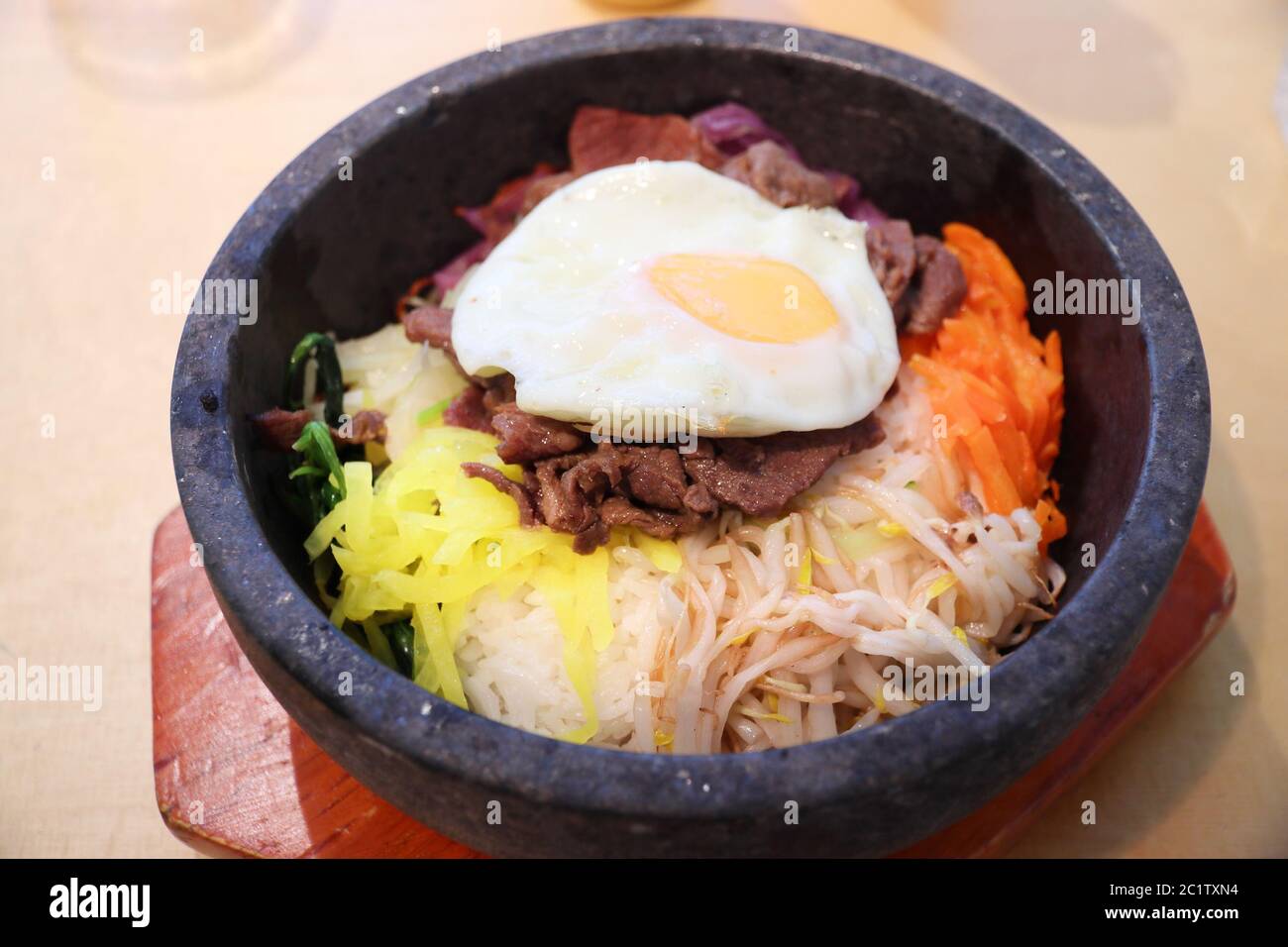 Bibimbap Korean cuisine dish served in a stone bowl Stock Photo - Alamy