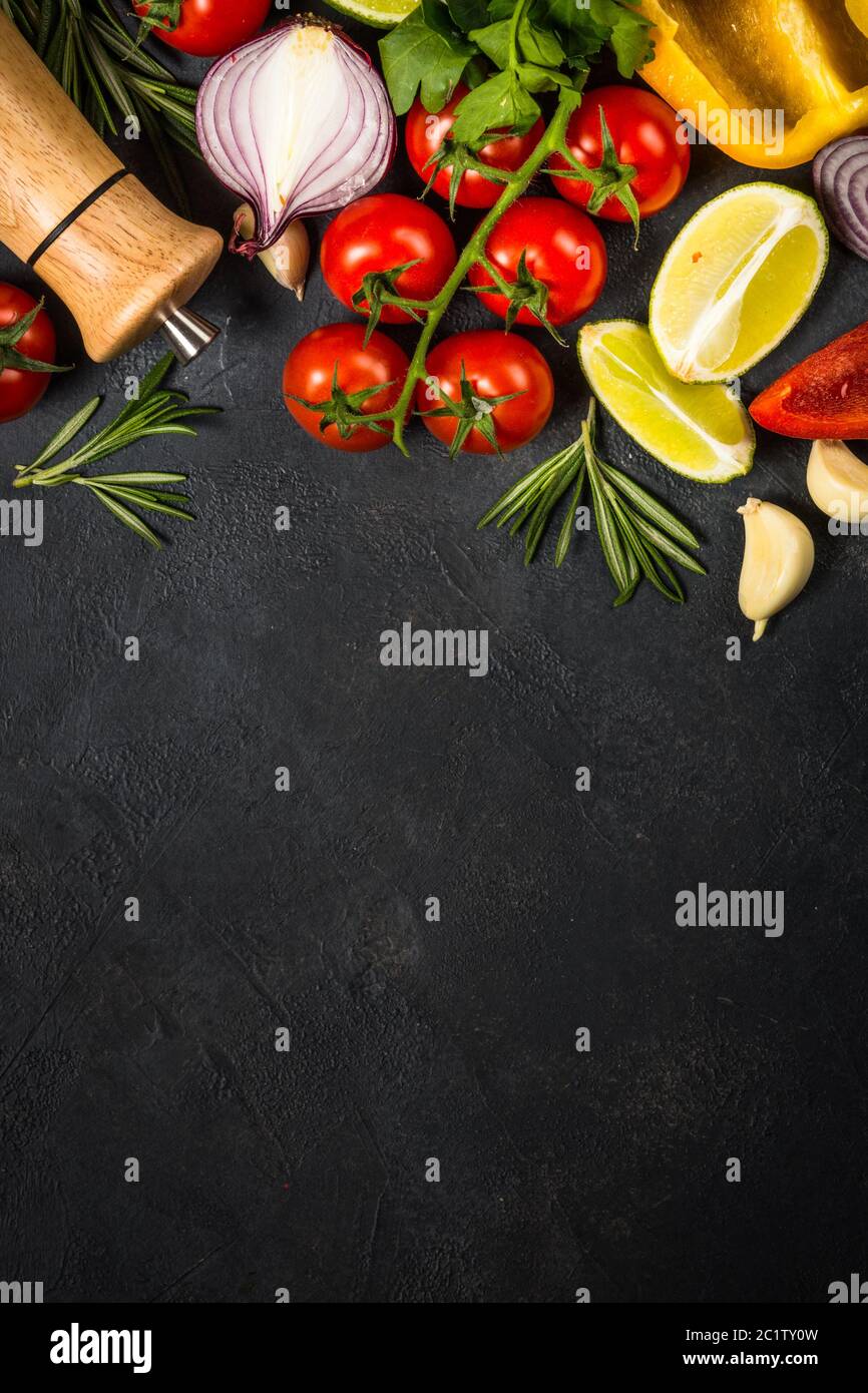 Food cooking background on black table Stock Photo - Alamy