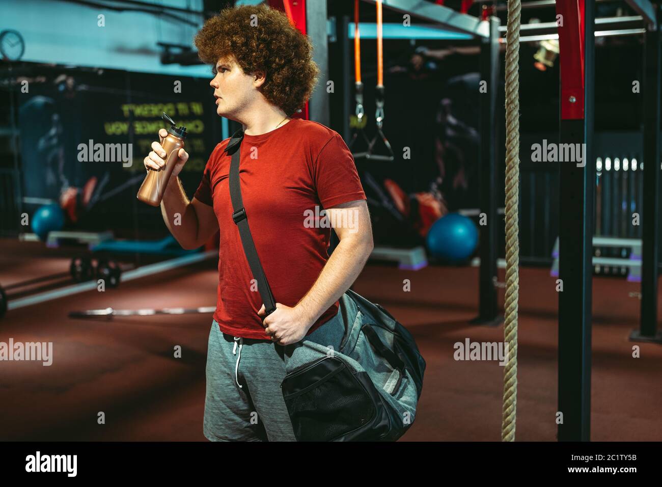 Overweight young man exercising in gym to achieve goals Stock Photo - Alamy