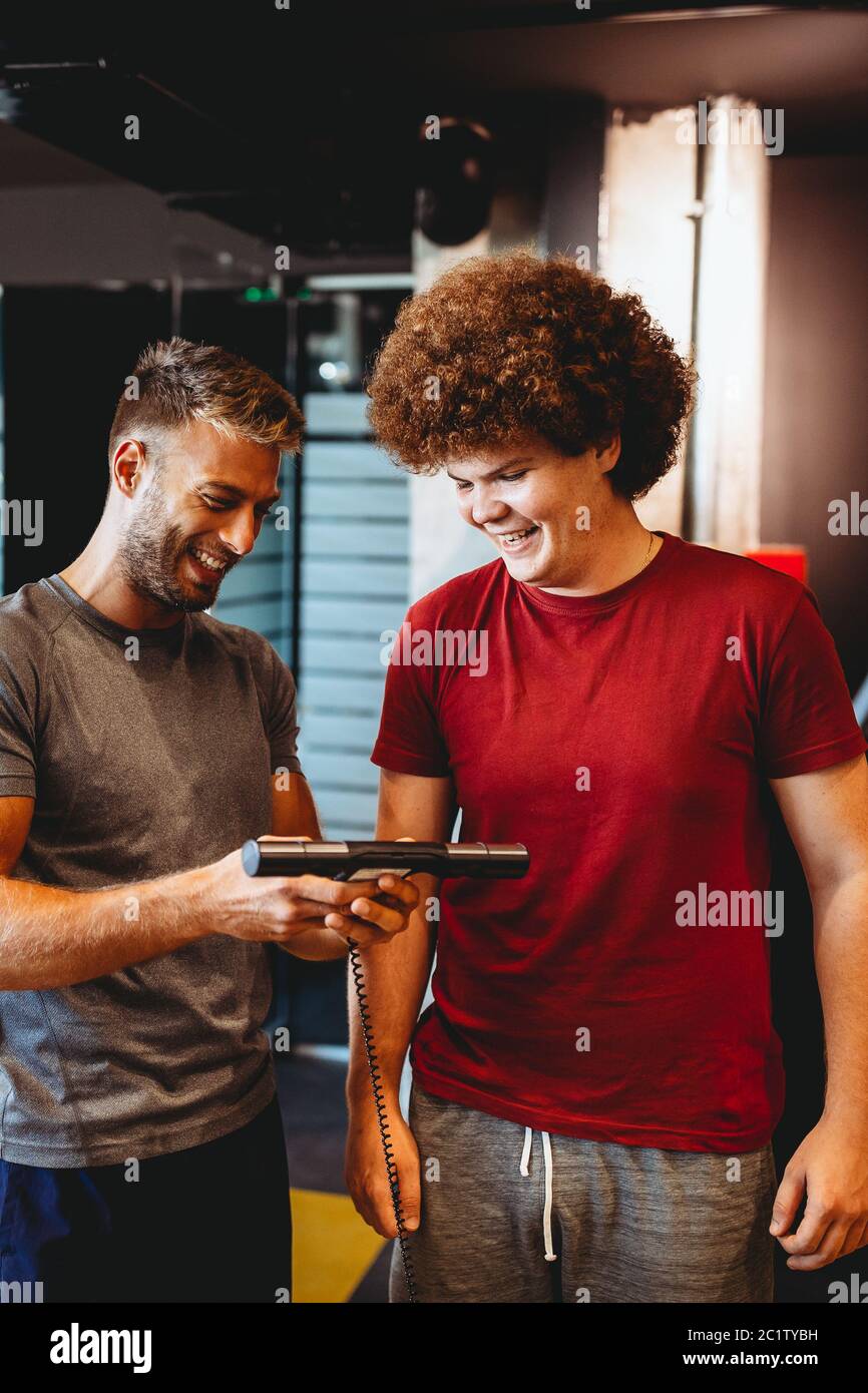 Happy overweight man with personal trainer, achieve goals, success ...