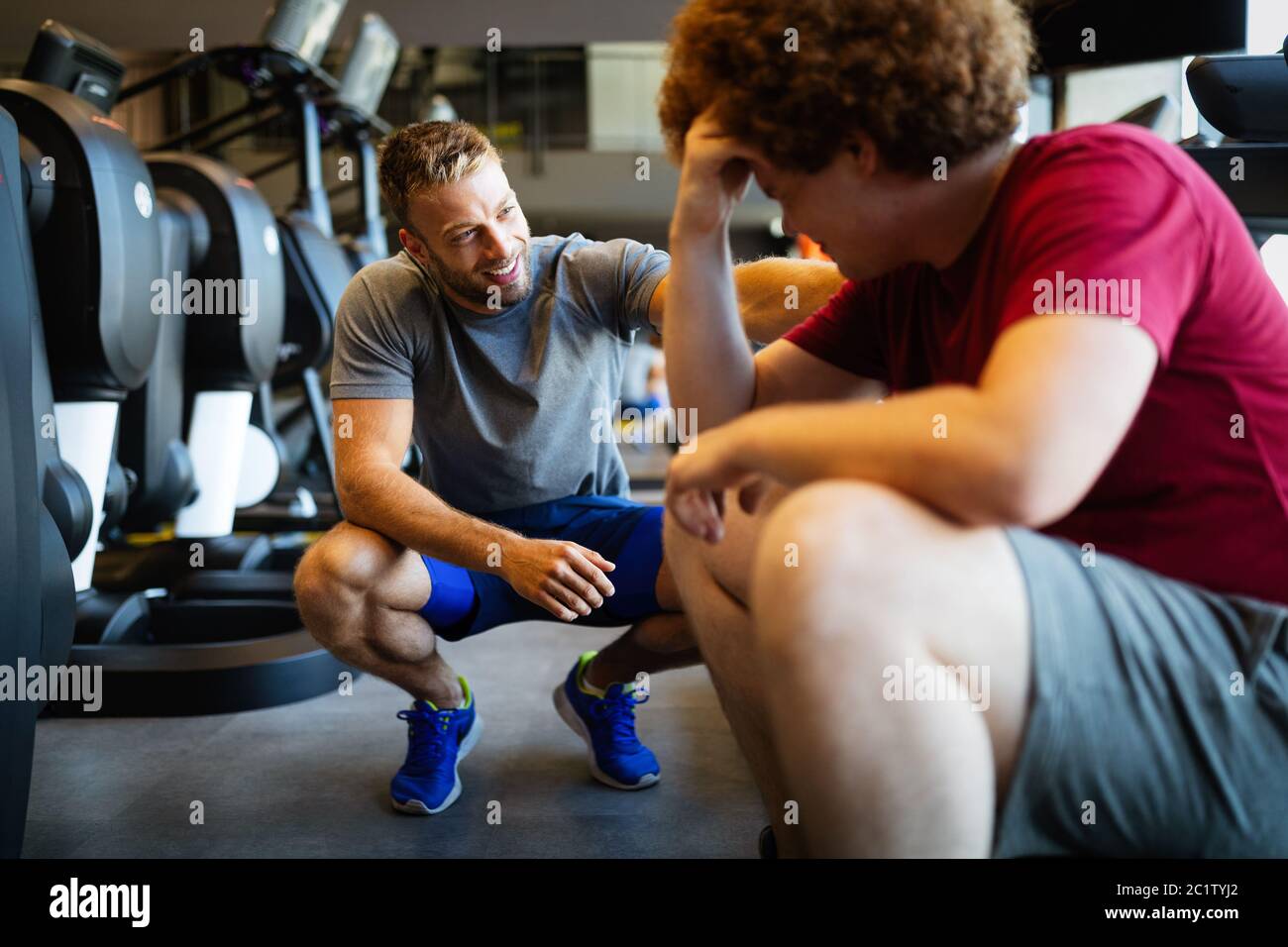 Tired fat man thinking over weight problems, desire to lose weight, gym ...