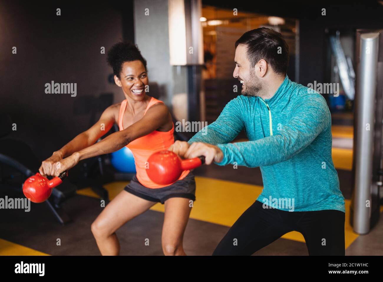 Group of young happy fit people doing exercises in gym Stock Photo - Alamy