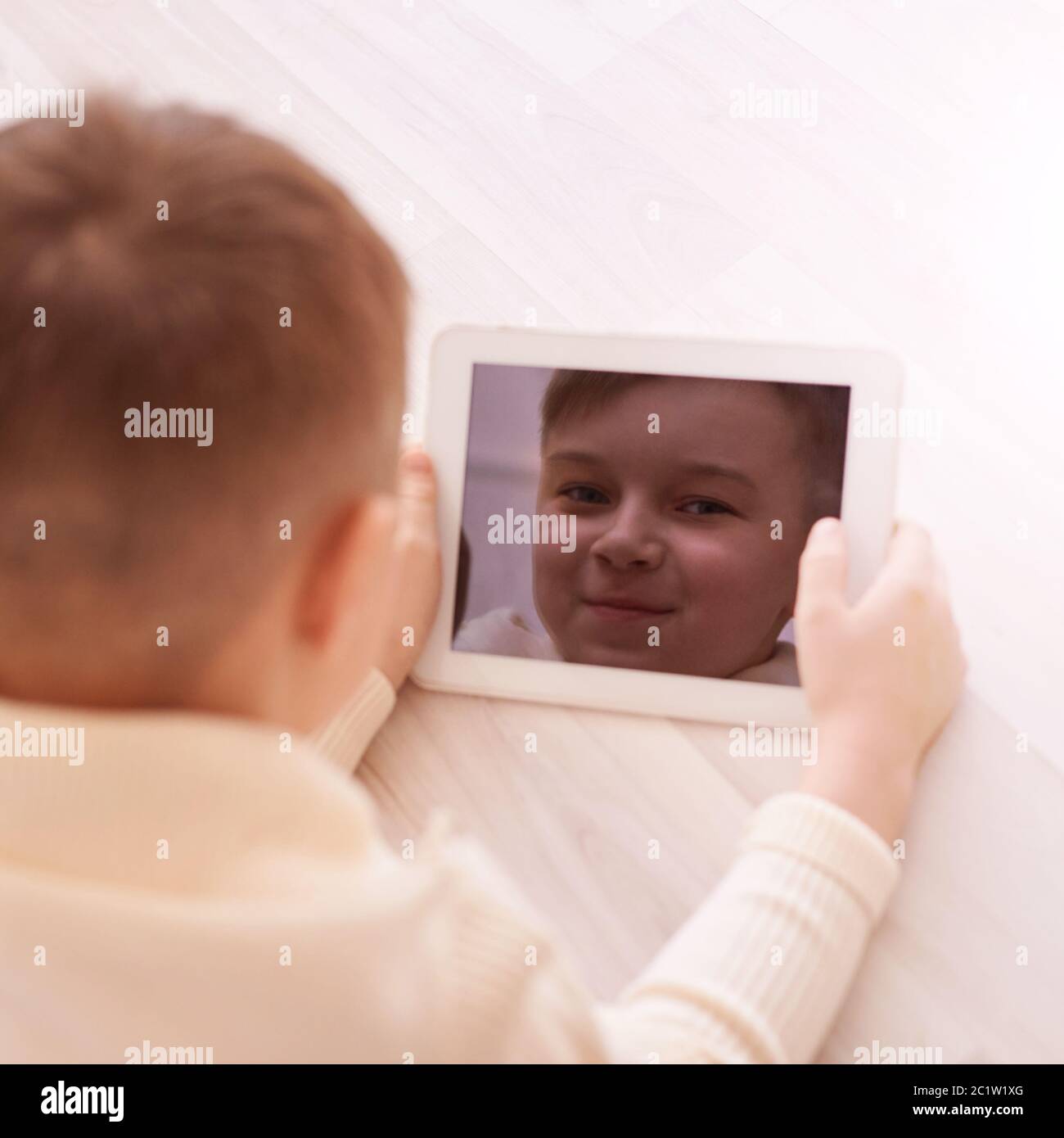 Cute boy. Face on screen. Light background. Horizontal Stock Photo - Alamy