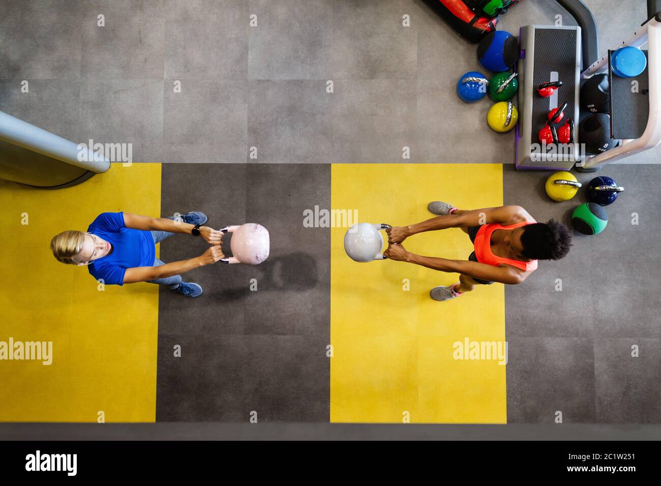 Group of young happy fit people doing exercises in gym Stock Photo - Alamy