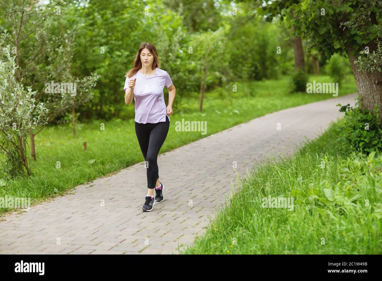 Girl jogging in the park. Healthy lifestyle concept Stock Photo - Alamy