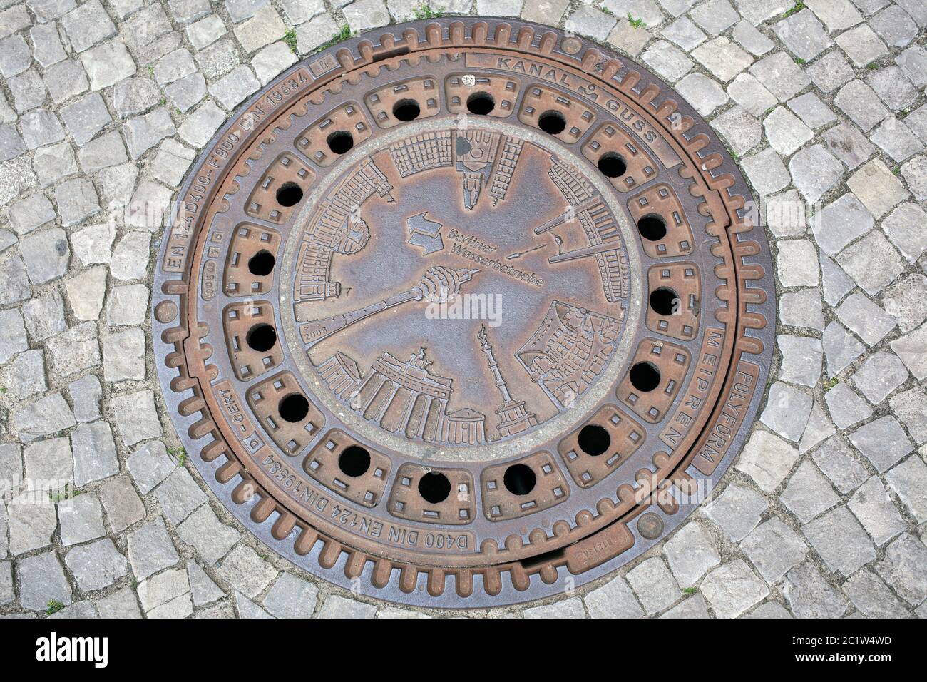 A cover of a sewer in Berlin, Germany on June 19, 2019. An electric ...