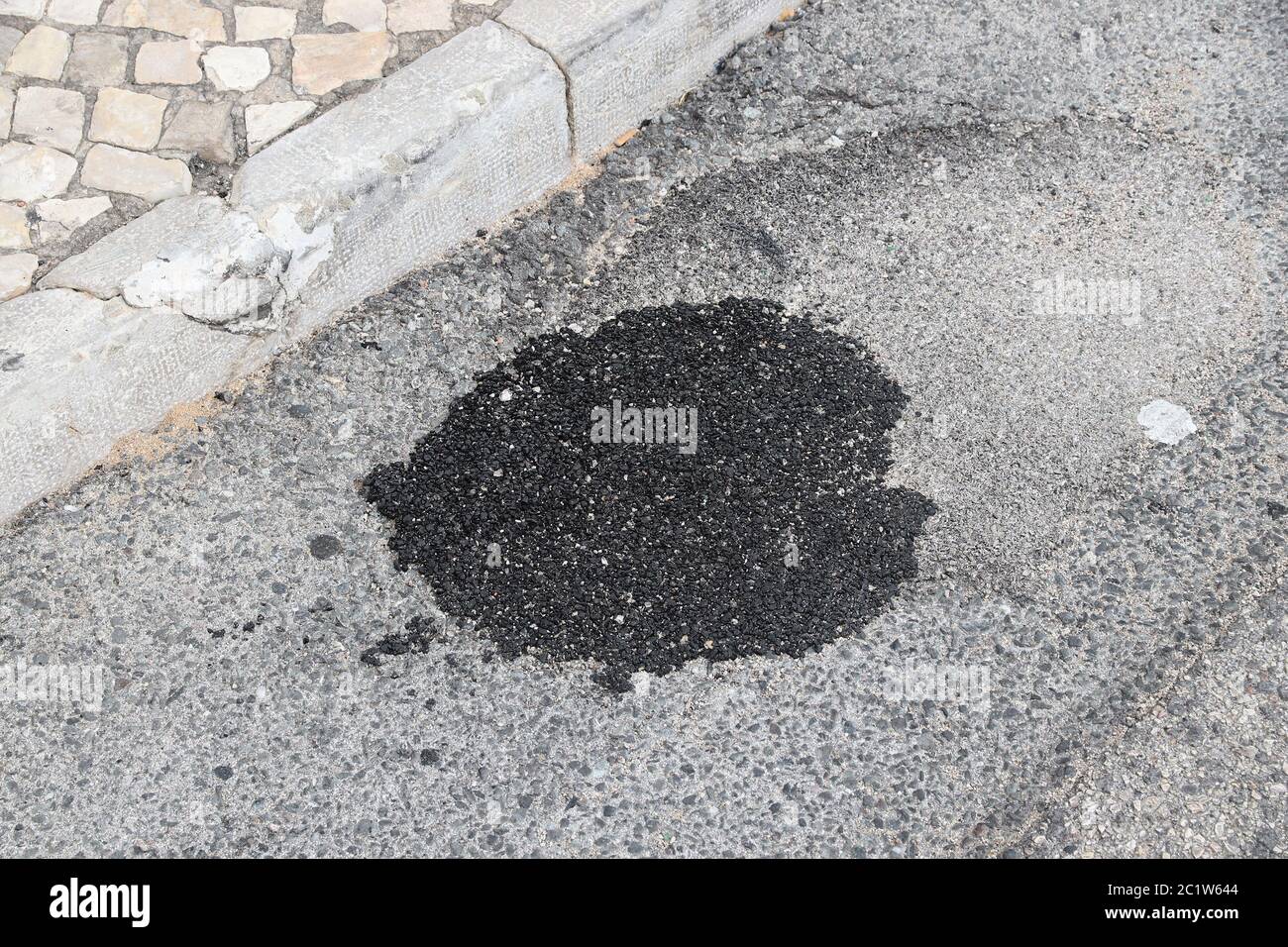 Patched pothole in local street in Albufeira, Portugal. Road ...