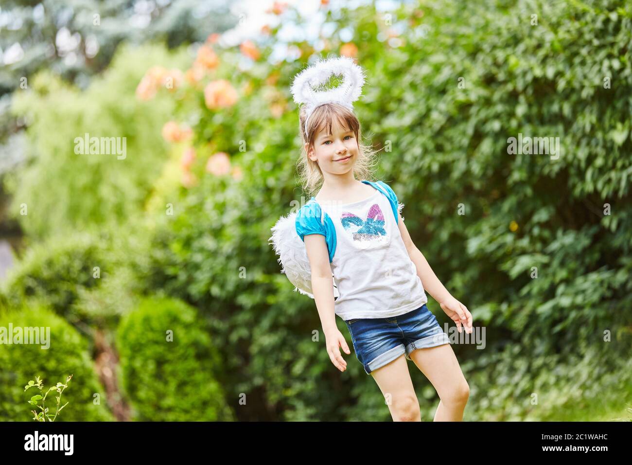 Good child as an angel with a halo at a carnival in the garden Stock ...