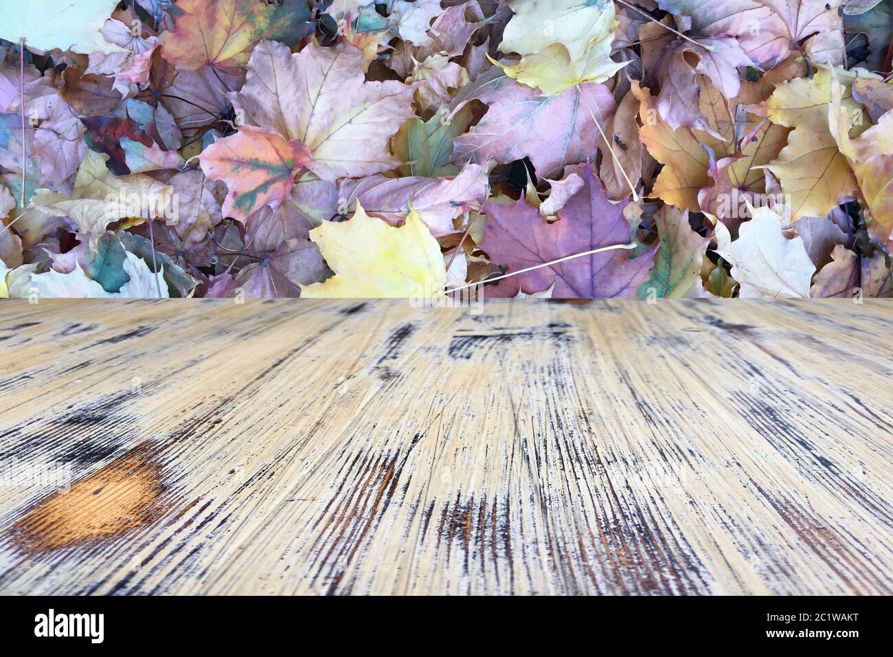 Wooden Table With Orange Leaves And Blurred Autumn Background Stock ...