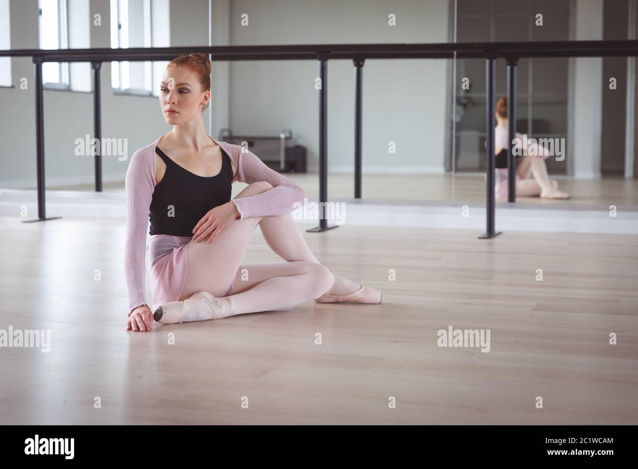 Caucasian female ballet dancer stretching out in a bright studio Stock ...