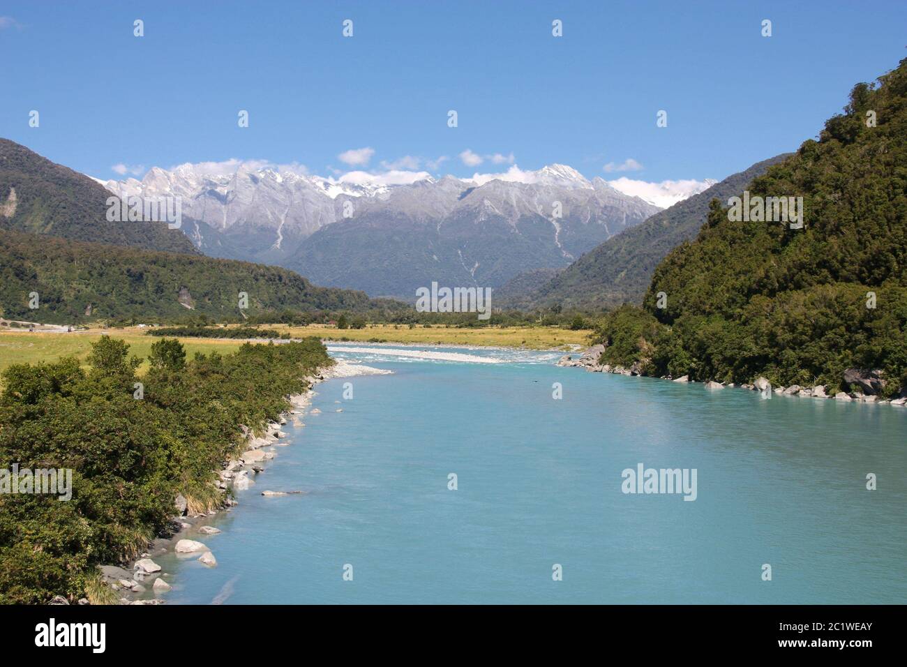 New Zealand landscape. Whataroa River and Southern Alps mountain range ...