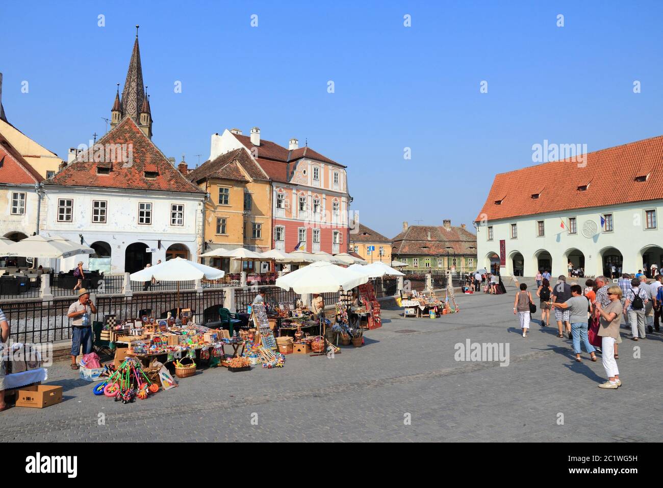 SIBIU, ROMANIA - AUGUST 24, 2012: People visit Piata Mica square in ...
