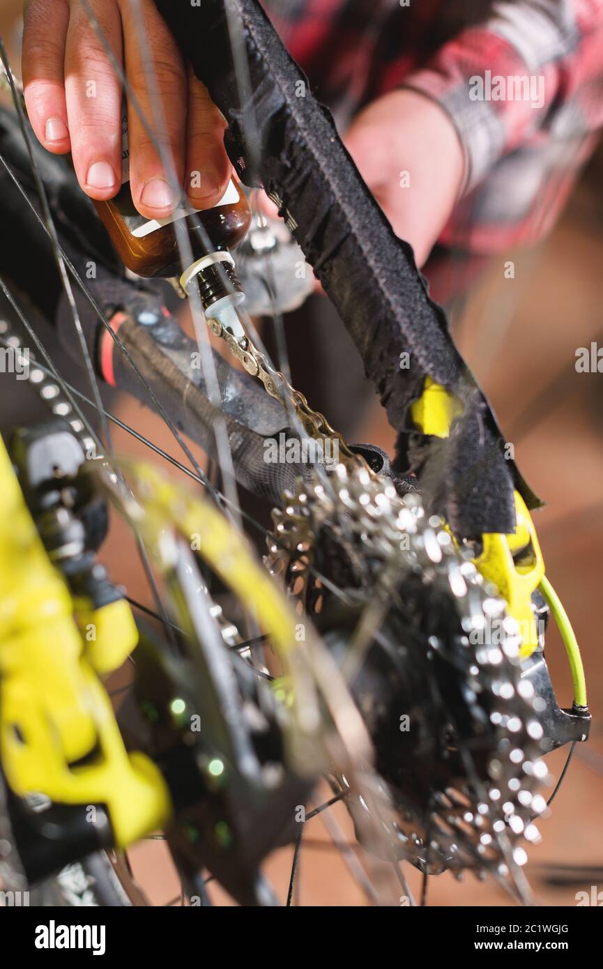 Close-up of men's hands led by masters grease with special grease ...