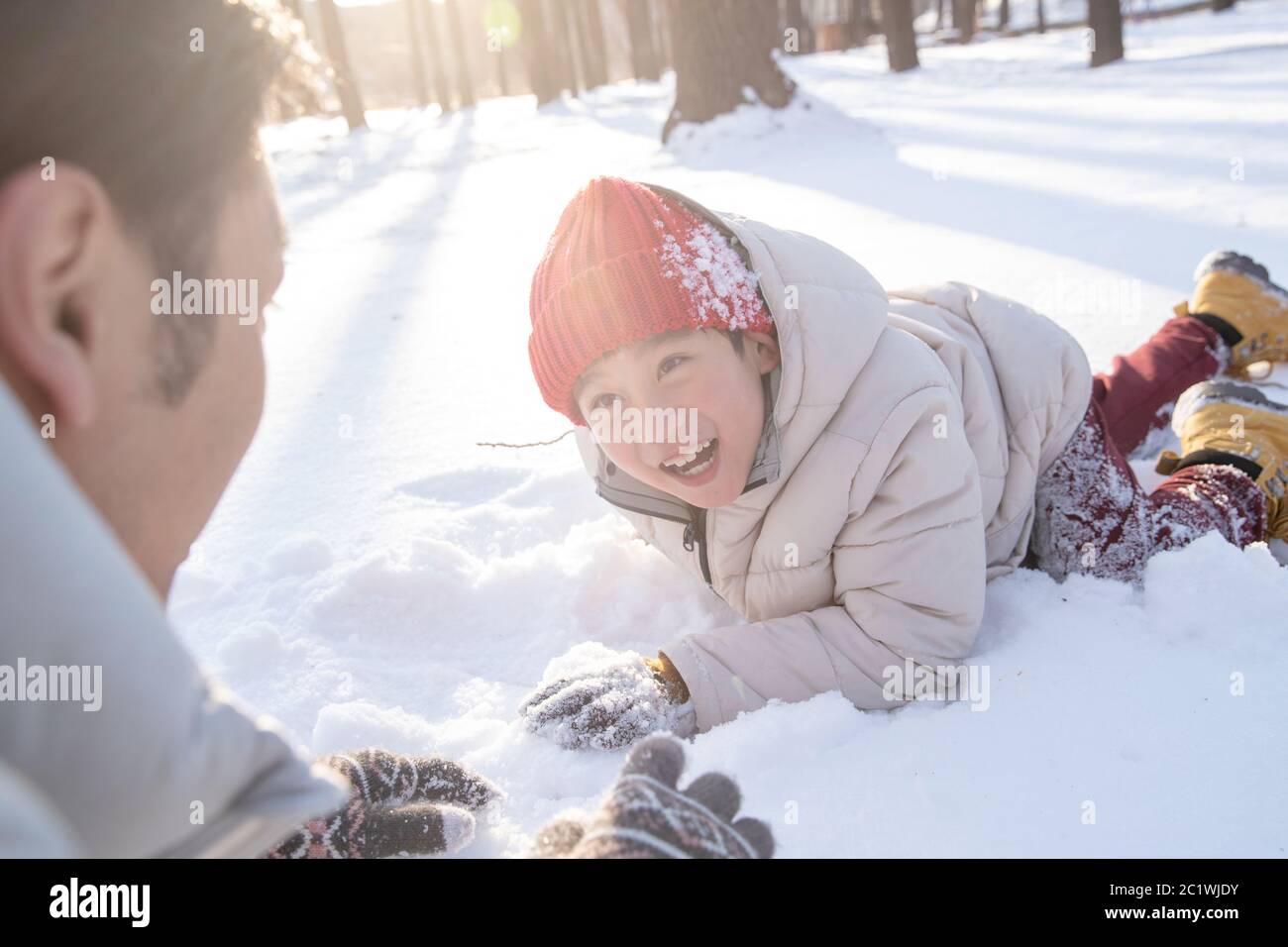 Happy father and son play in the snow Stock Photo - Alamy