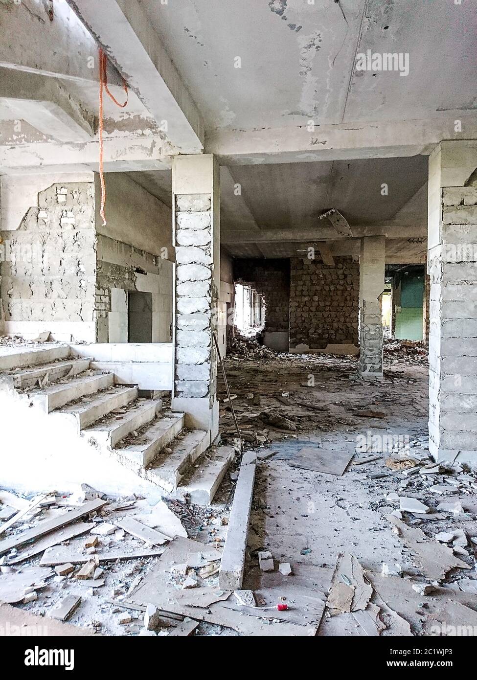 The ruins of a large destroyed building, pieces of stone, concrete ...