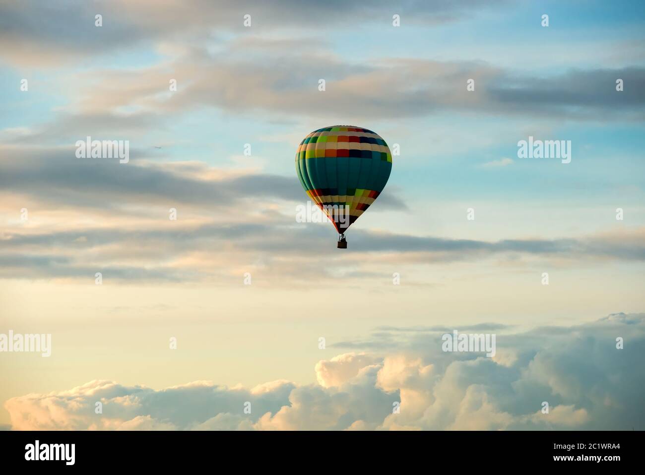 Colorful big hot air balloon flying against the cloudy sky Stock Photo ...