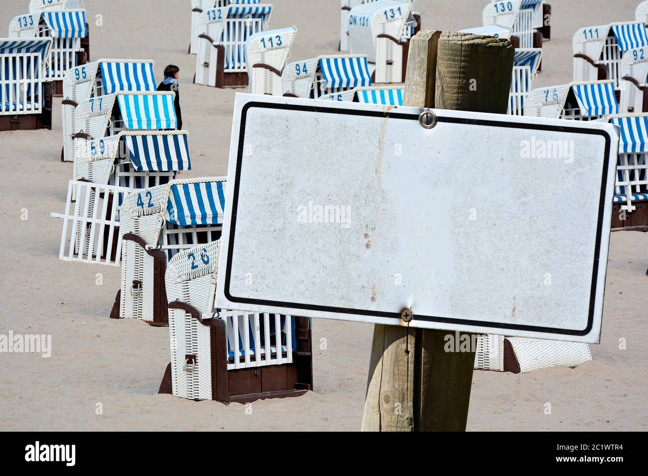 Empty signboard with copy space in front of beach chairs on the beach of the Baltic Sea in ...