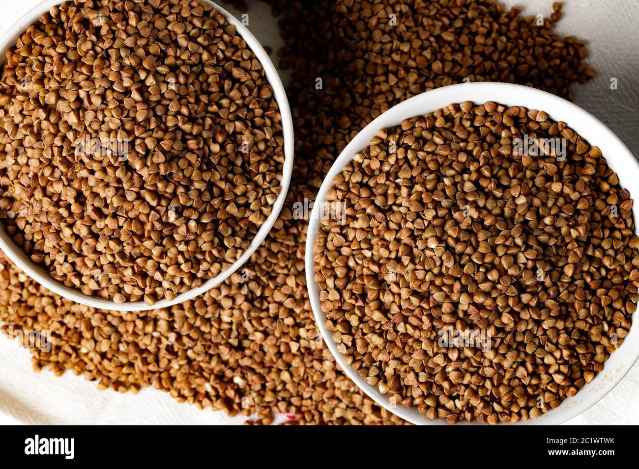 Bowl of raw uncooked buckwheat on wooden table Stock Photo - Alamy