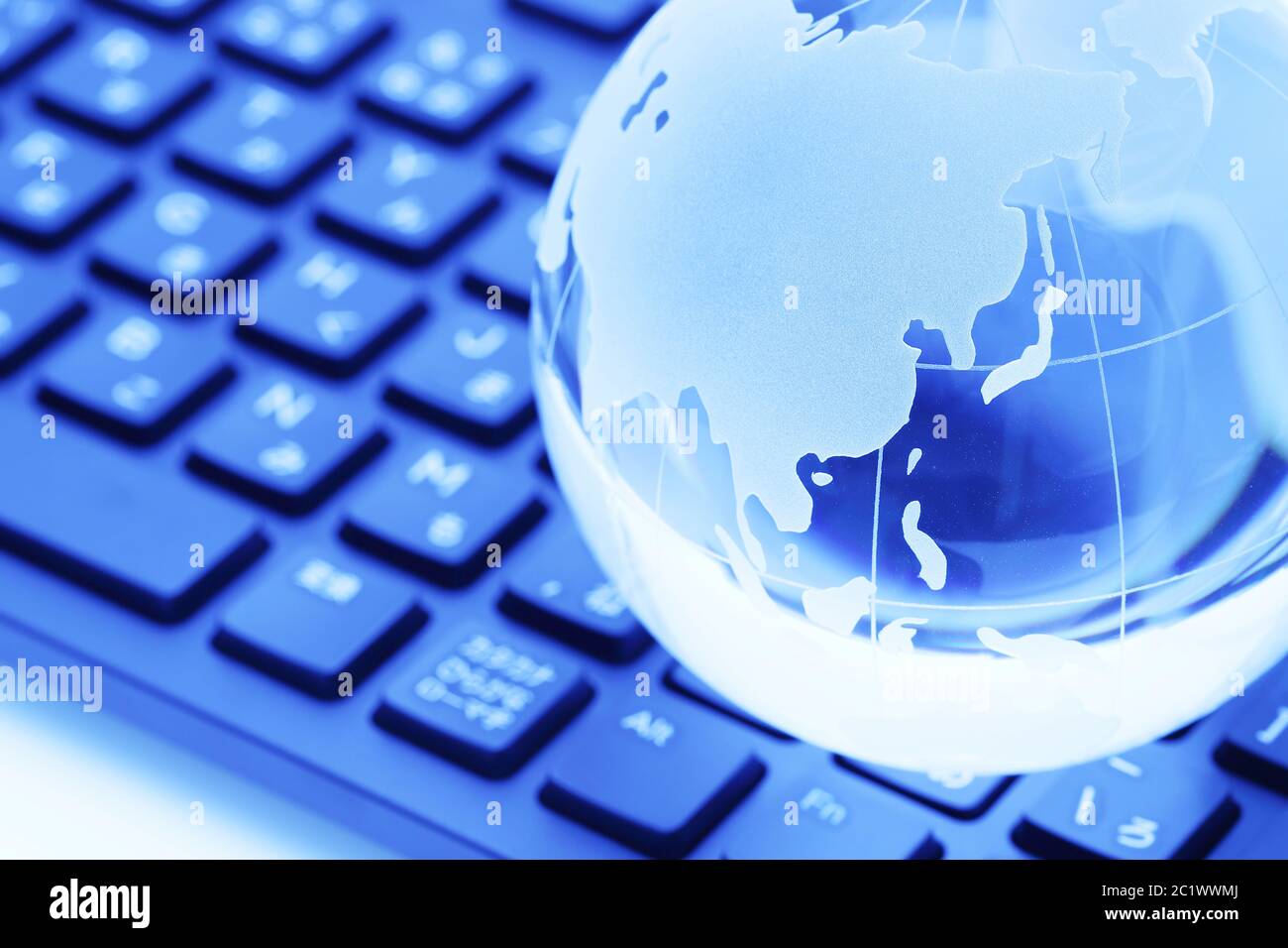 Glass globe ball with keyboard on white background Stock Photo - Alamy