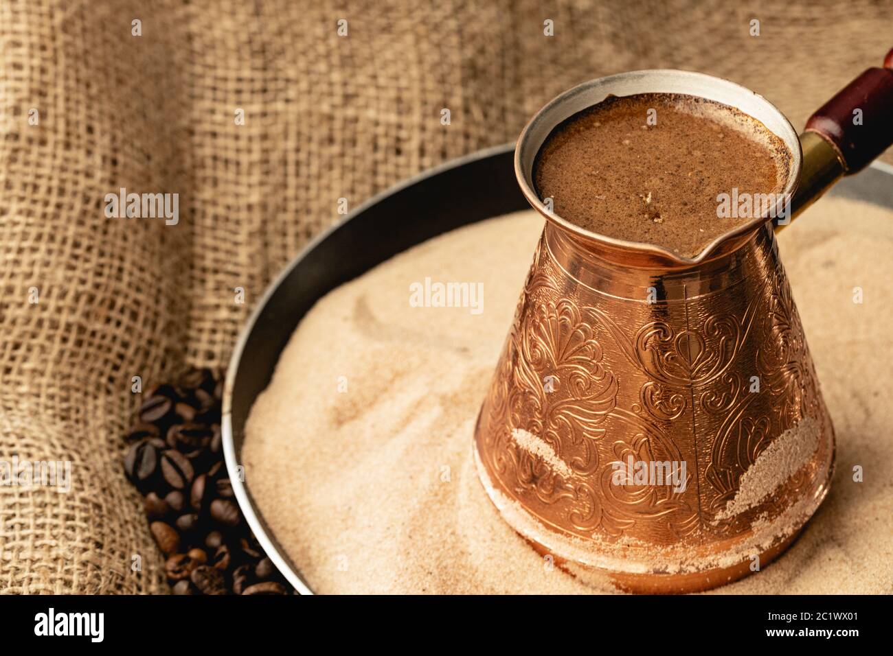 Turkish coffee prepared in sand with turk Stock Photo - Alamy