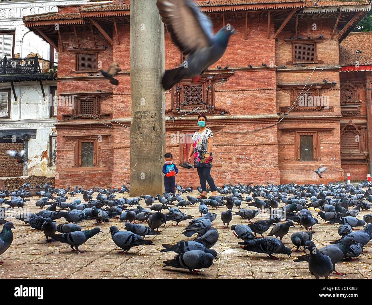 Kathmandu, Nepal. 16th June, 2020. A Nepali kid and his mother feed ...