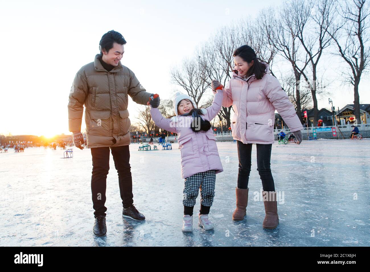 The three playing skating rink Stock Photo - Alamy