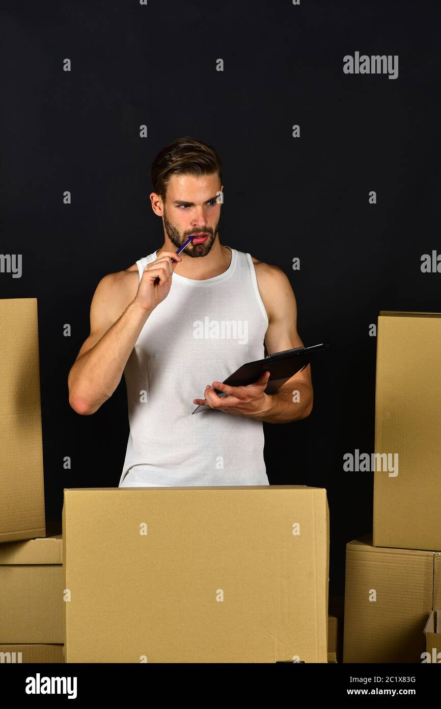 Macho with beard and thoughtful face. Delivery and moving in concept ...