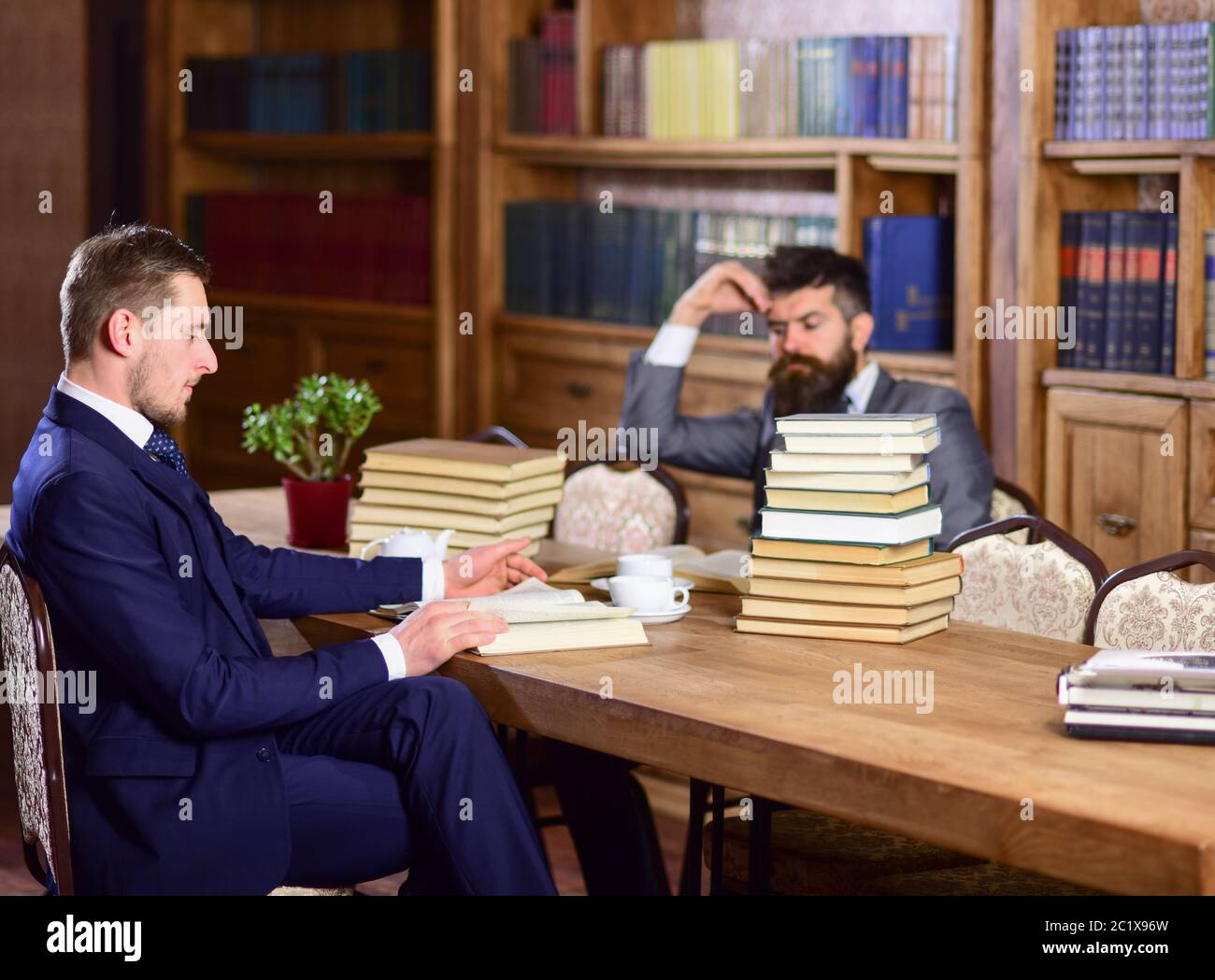 Men in suits, aristocrats, professors in library or vintage interior ...