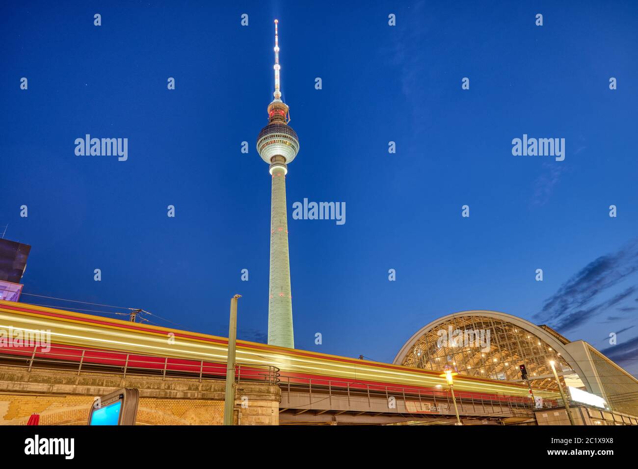 Commuter train entering Alexanderplatz Station in Berlin at night Stock ...