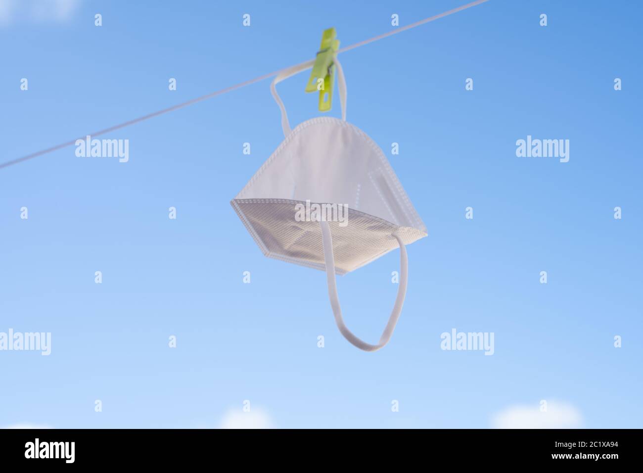 Mask hanging on clothesline Stock Photo - Alamy
