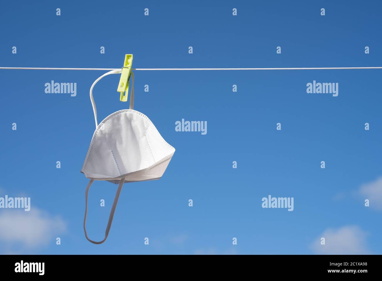 Mask hanging on clothesline Stock Photo - Alamy