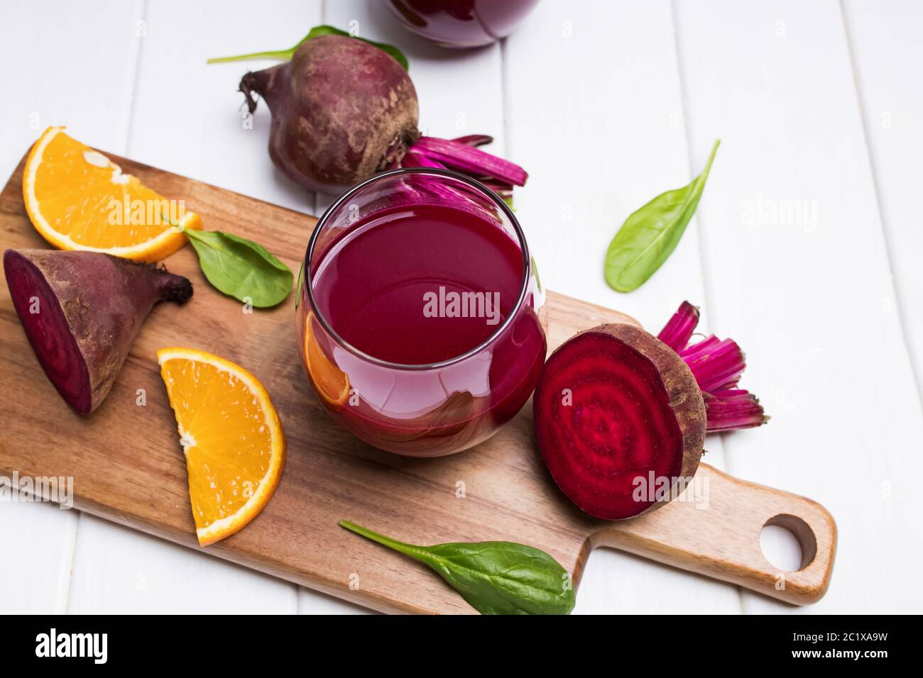 Healthy beetroot and orange juice in a jars on white table, top view ...