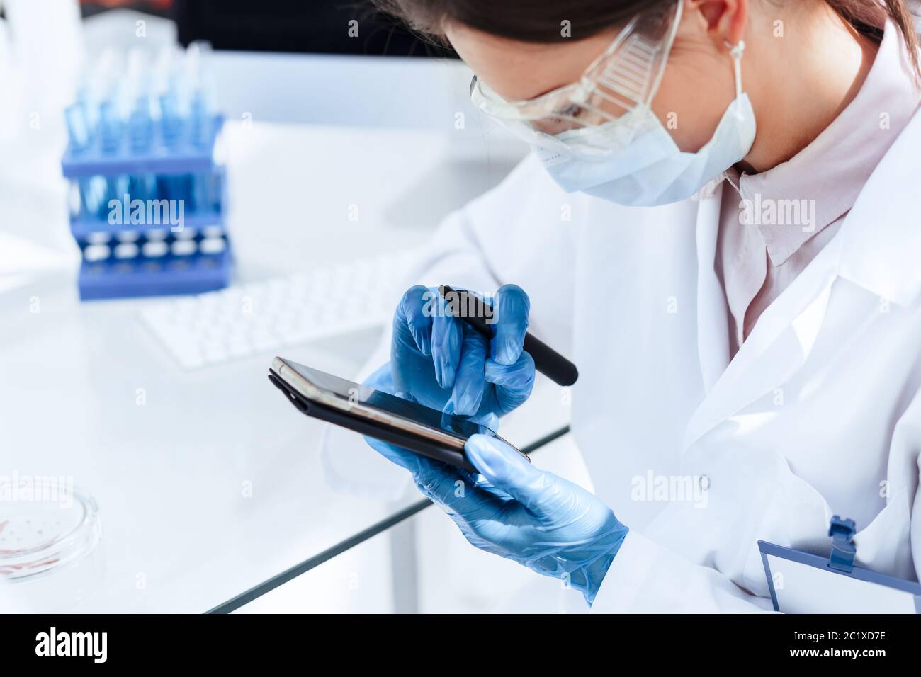 Female biology researcher using phone hi-res stock photography and ...