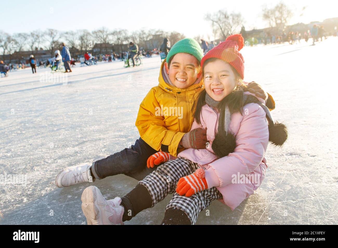 The happy children playing skating rink Stock Photo - Alamy