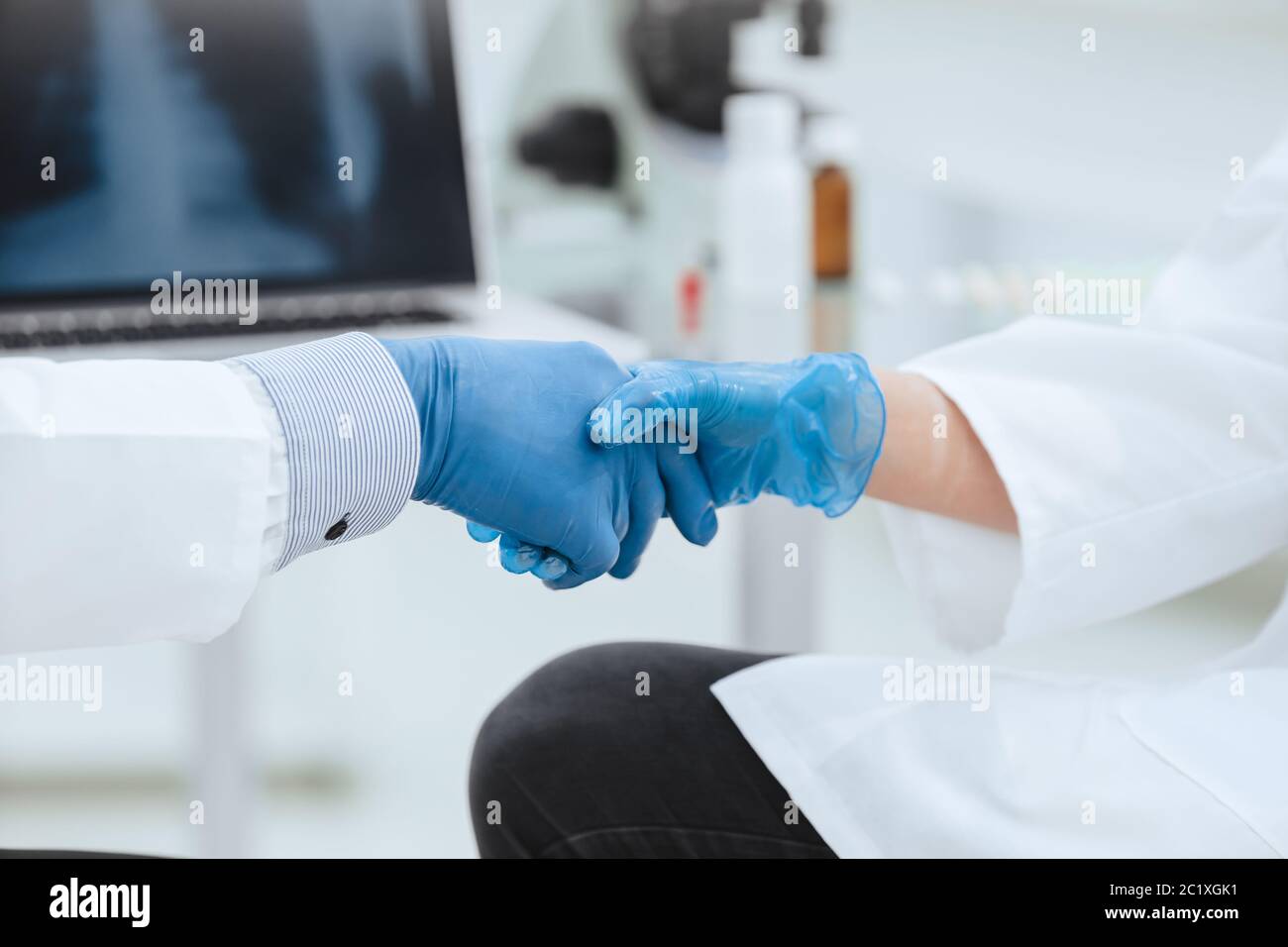 Scientists shaking hands in lab hi-res stock photography and images - Alamy