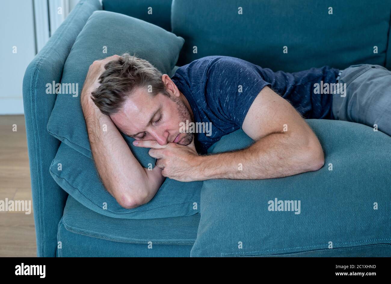Unhappy depressed caucasian male crying in living room couch feeling ...