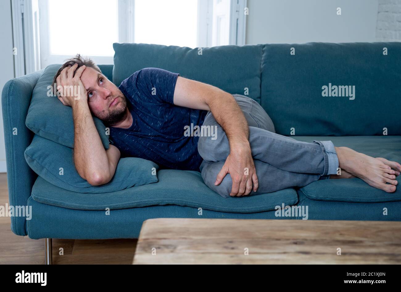 Unhappy depressed caucasian male crying in living room couch feeling ...