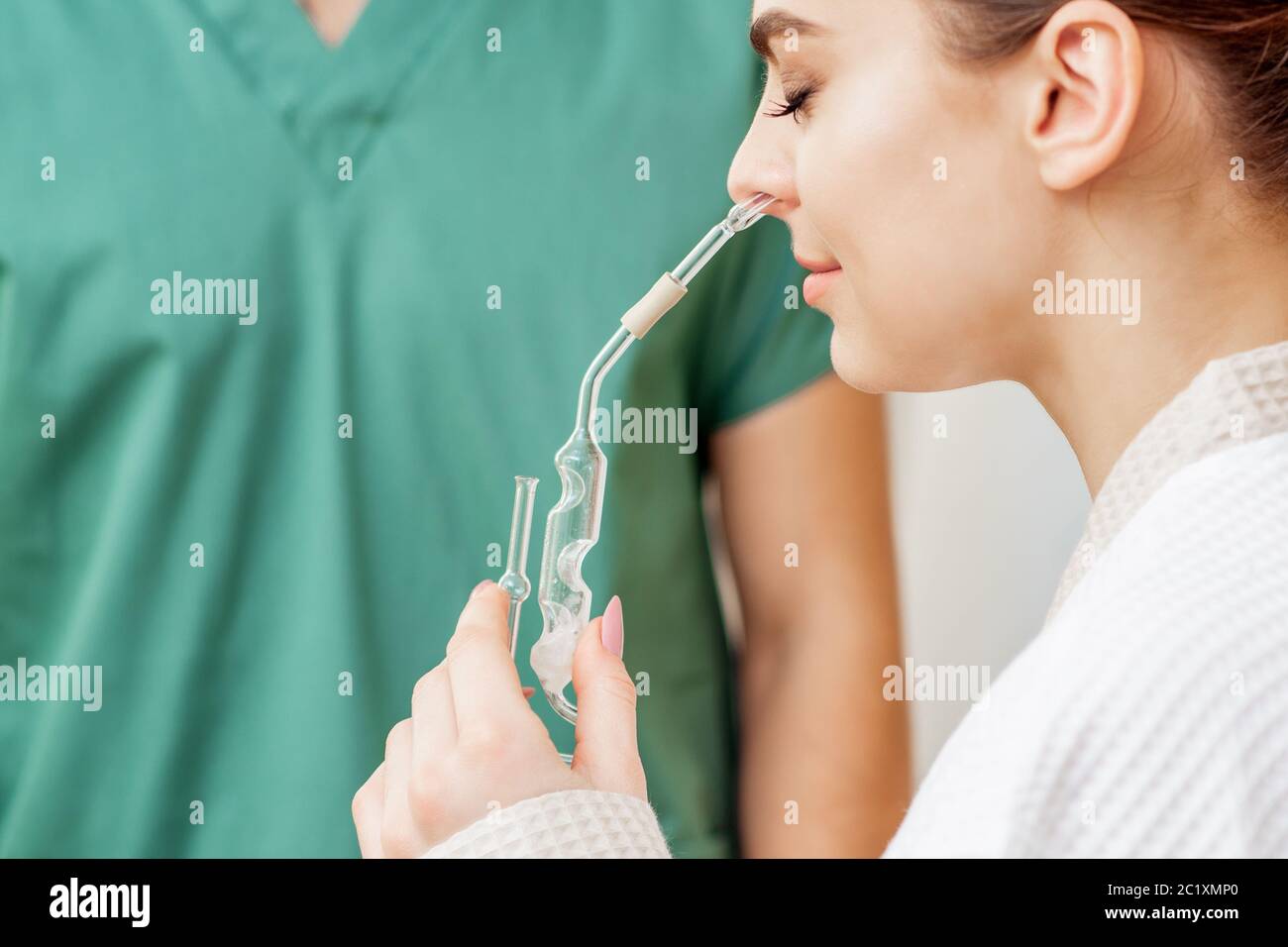 Woman receives nasal inhalation Maholda by essential oil in nose at spa ...