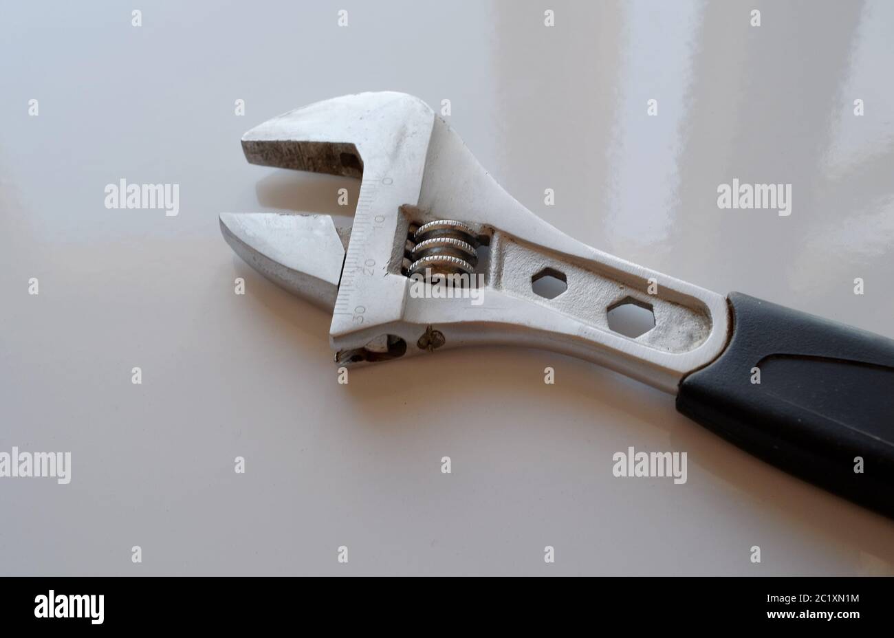 Adjustable spanner on a shiny light surface Stock Photo - Alamy