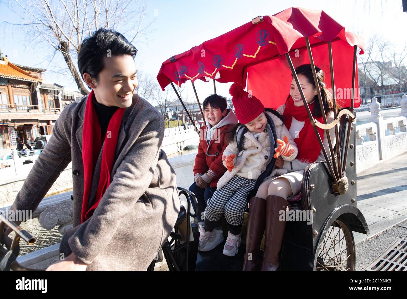 A family of four sat rickshaws to travel Stock Photo - Alamy