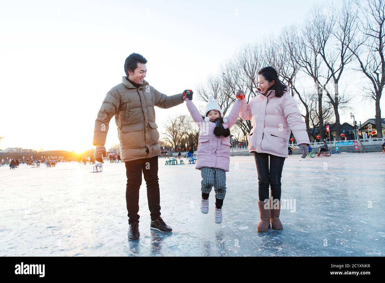 The three playing skating rink Stock Photo - Alamy