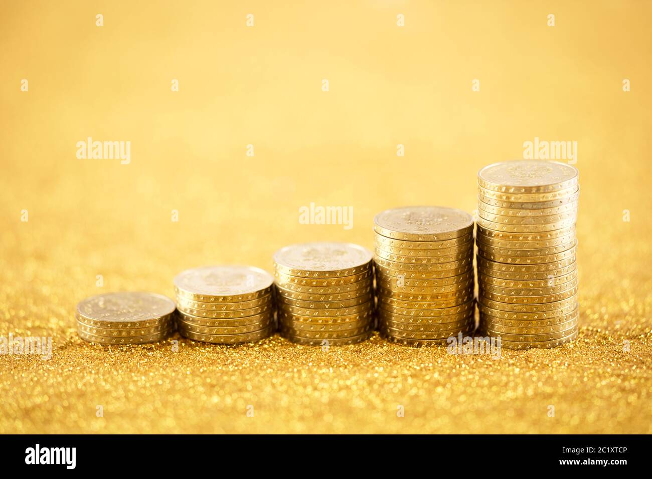 Rising golden coins Stock Photo - Alamy
