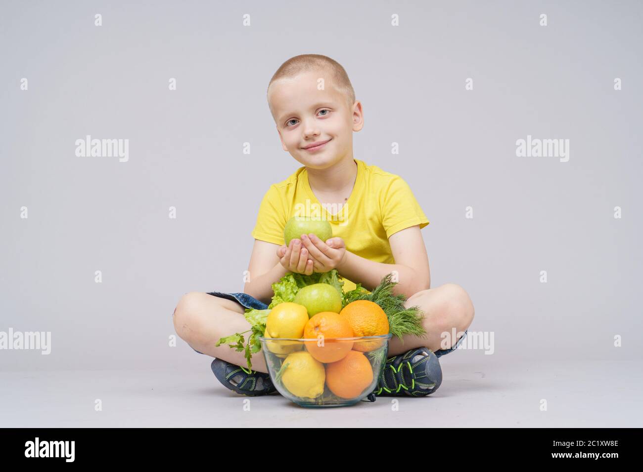 Cute children with healthy food. Isolated on gray background Stock ...