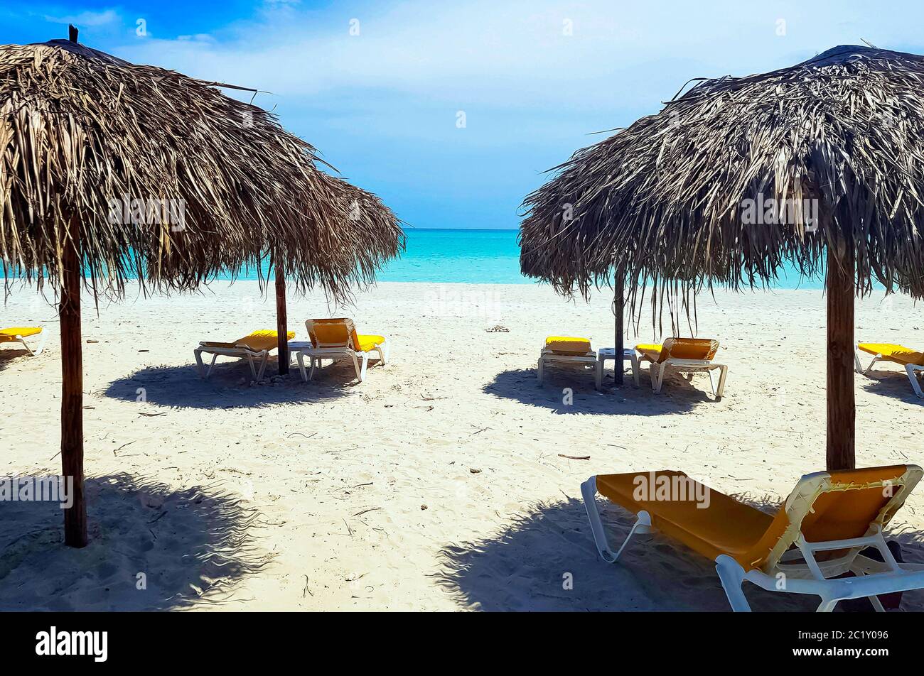 Cuban beach, umbrellas and sunbeds with Atlantic Ocean in background ...